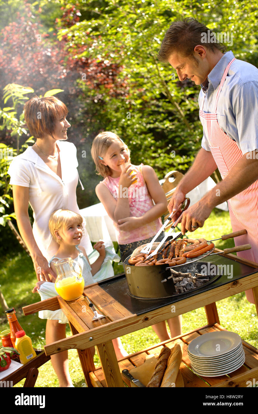 Family having a barbecue in the garden Stock Photo - Alamy