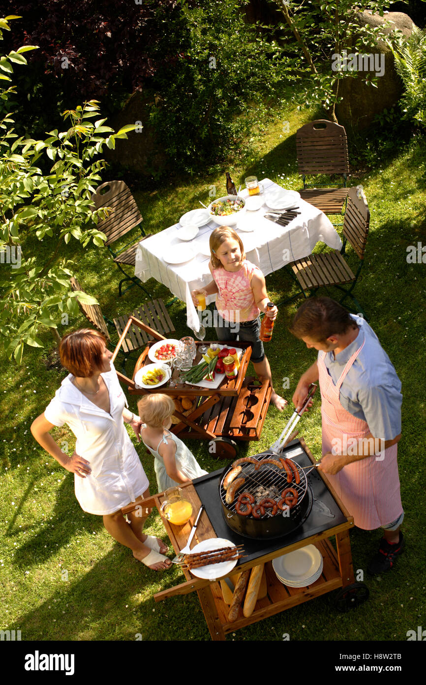 Family having a barbecue in the garden Stock Photo - Alamy