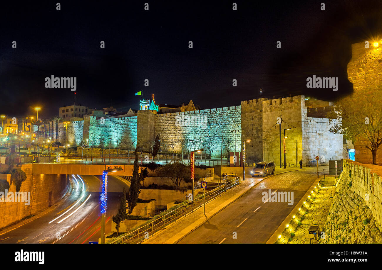 The evening city with the bright illuminated walls of the Jerusalem ...