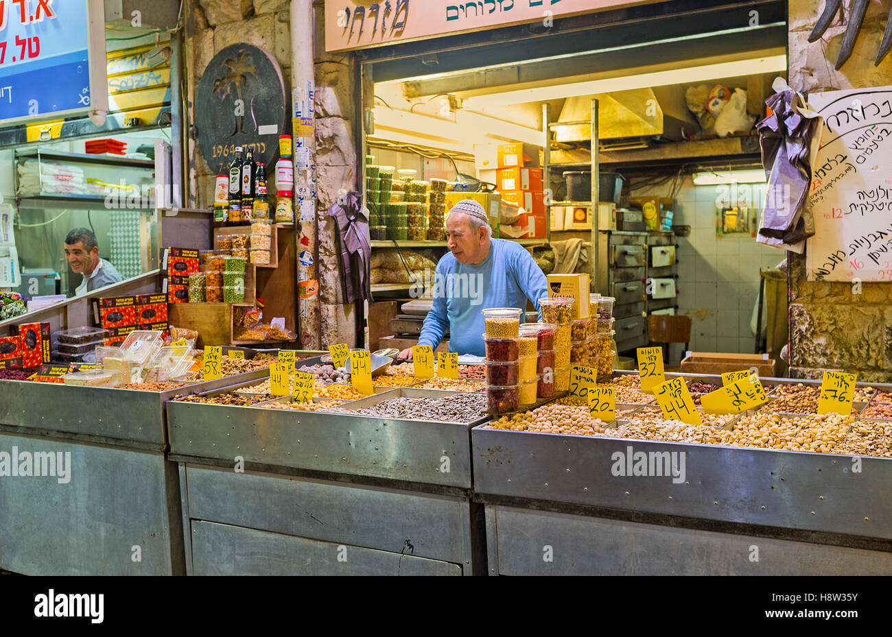 The senior merchant in stall of Mahane Yehuda market offers the dried ...