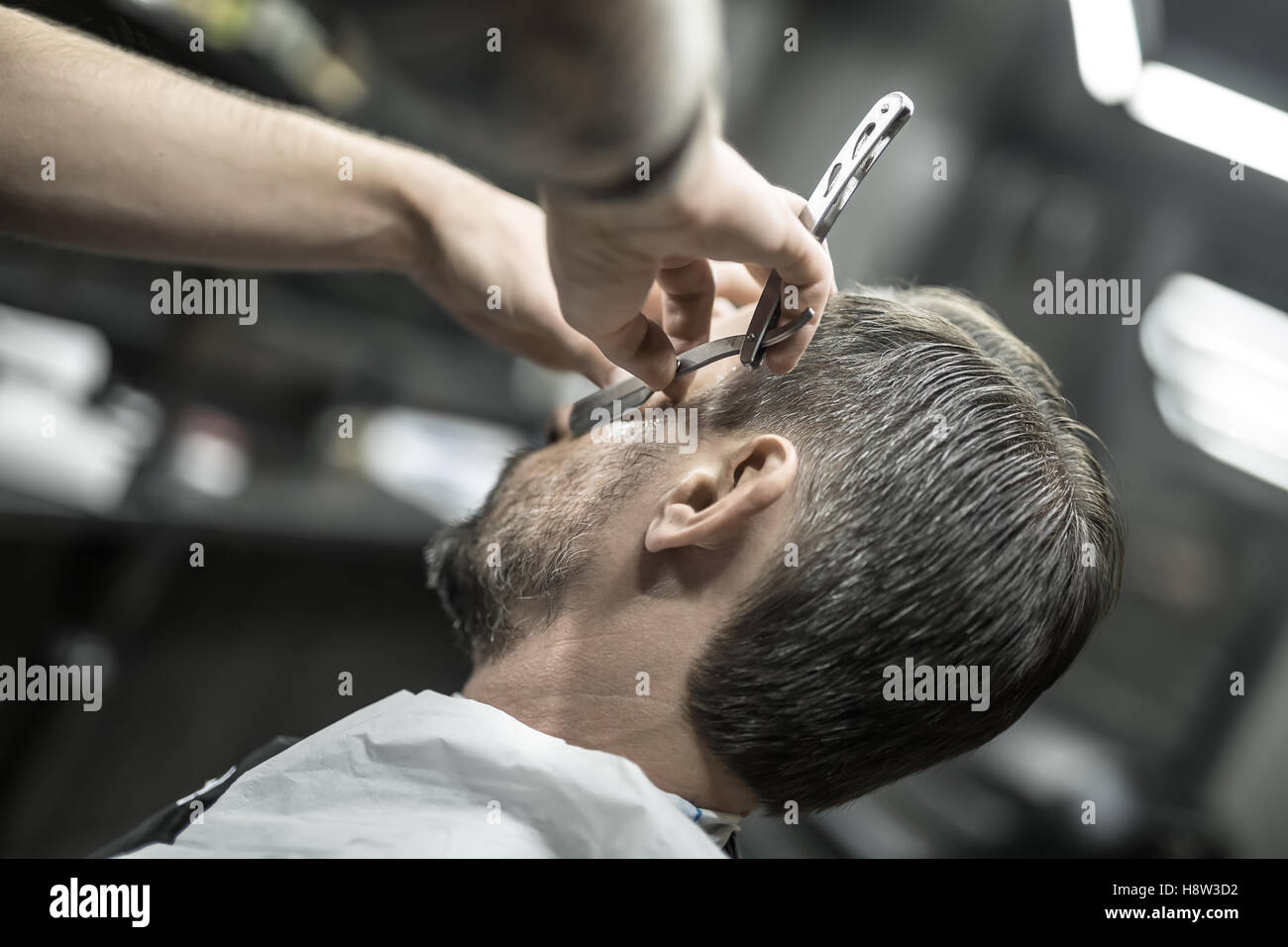 Barber trimming man hi-res stock photography and images - Alamy