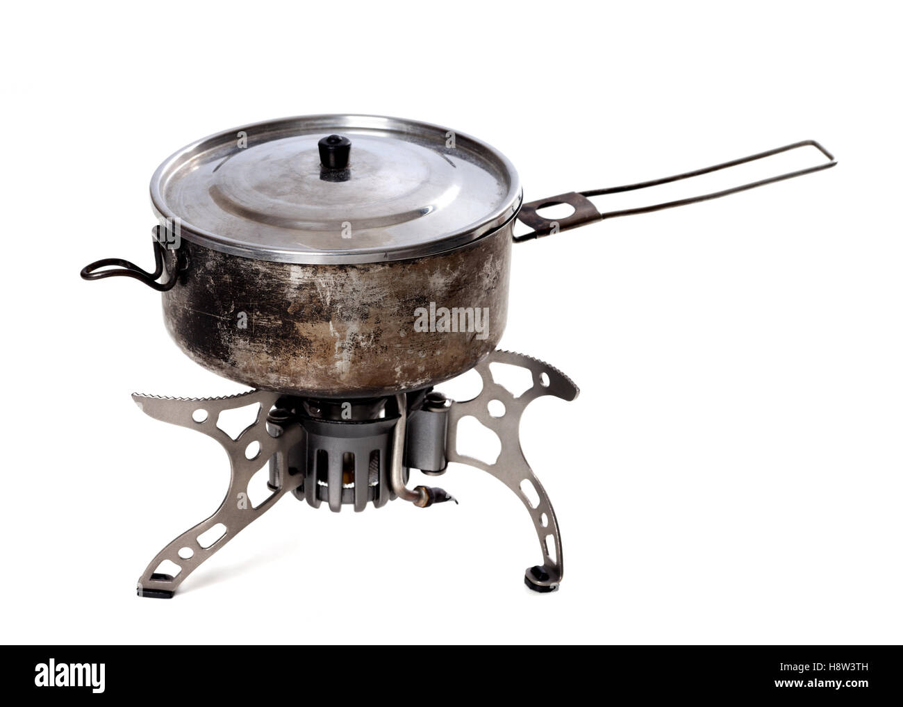 Camping gas stove and old sooty hiking pan. Isolated on white ...
