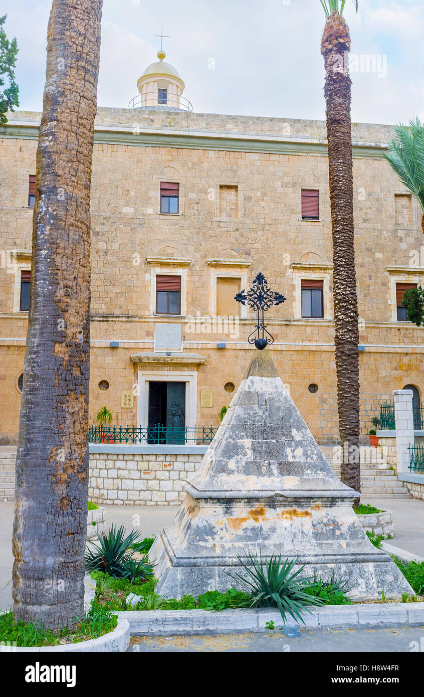 The small pyramid-shaped memorial stone, with an iron cross on the top ...