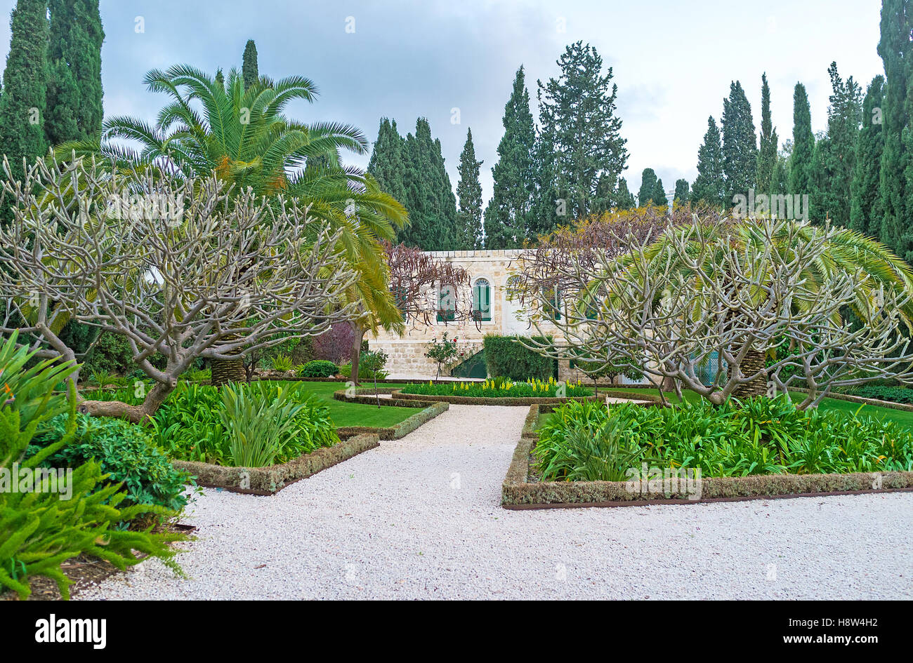The stone residential mansion, surrounded by the lush garden with ...
