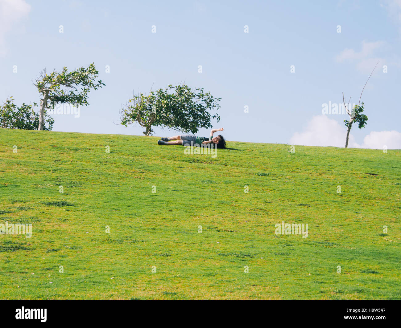 Boy lying on grass arms hi-res stock photography and images - Alamy