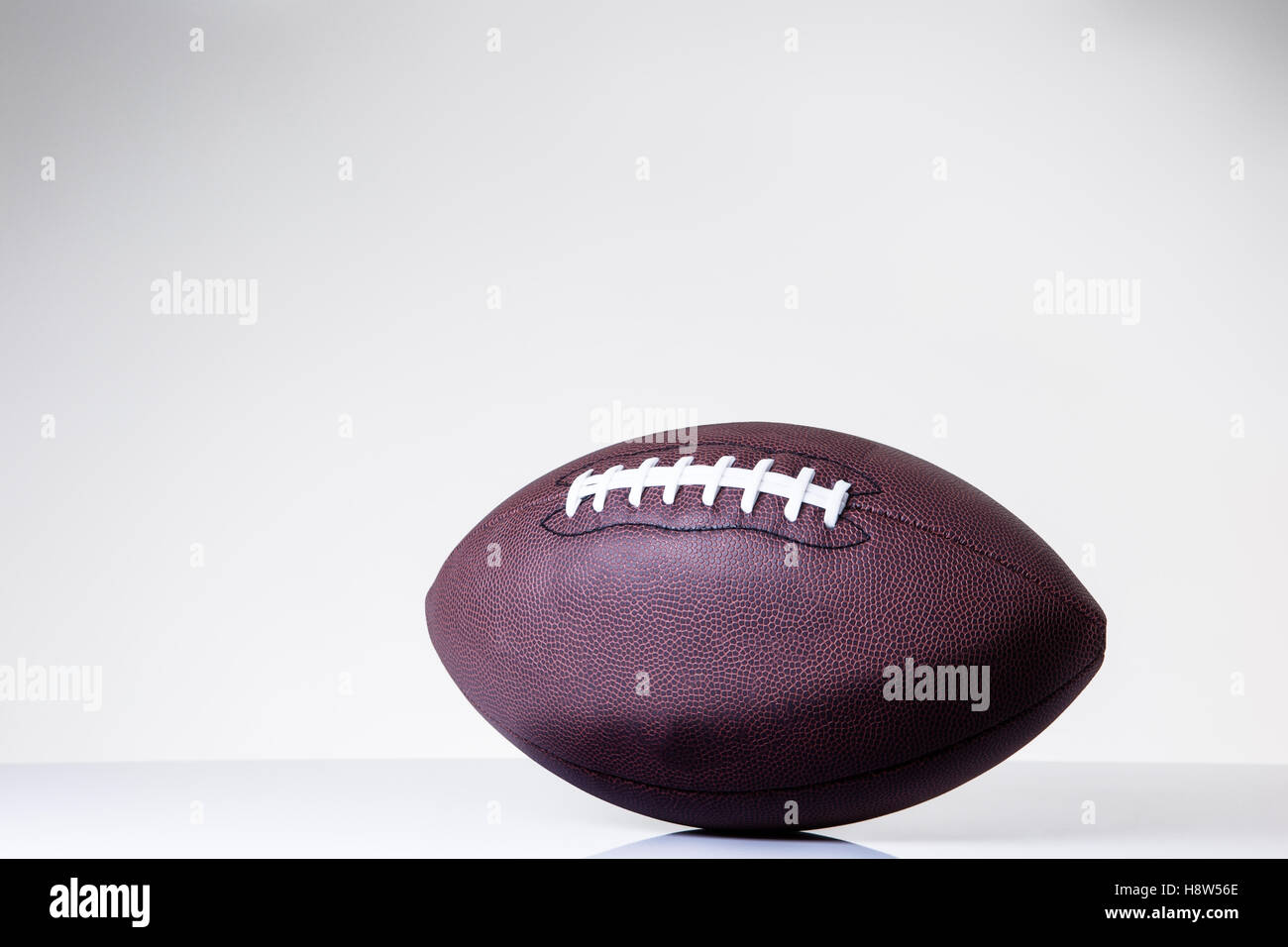 still life image of american football shot in the studio on a white ...