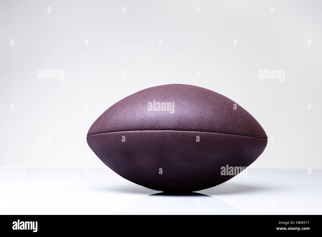 still life image of american football shot in the studio on a white ...