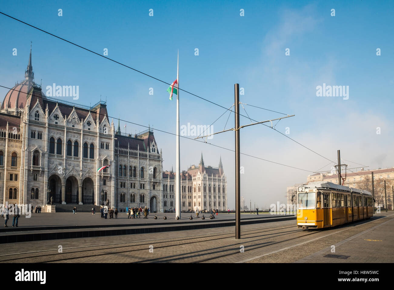 Building of the Budapest parliament. Yellow tram in front Stock Photo ...