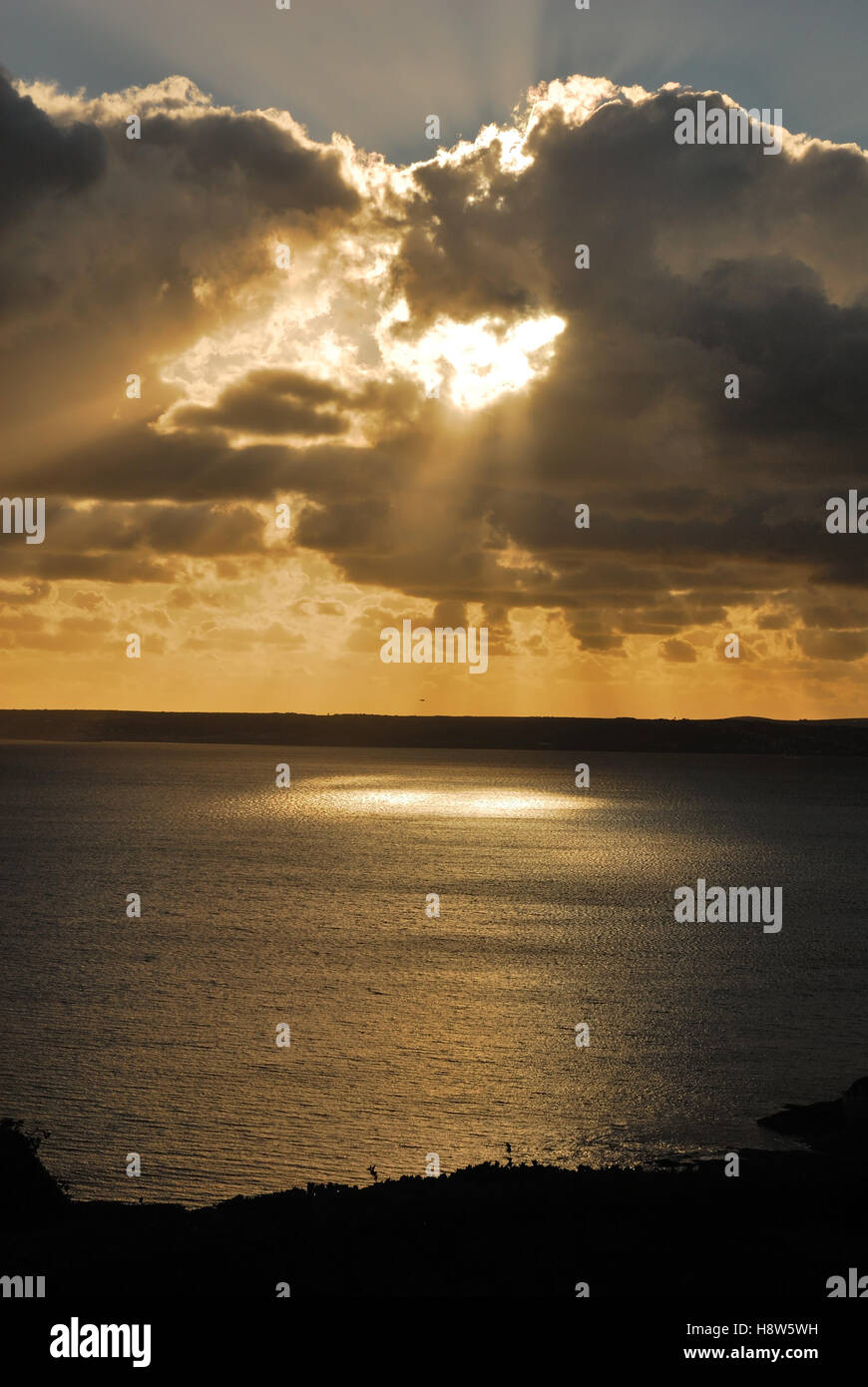 Sun-rays and clouds over the sea Stock Photo - Alamy
