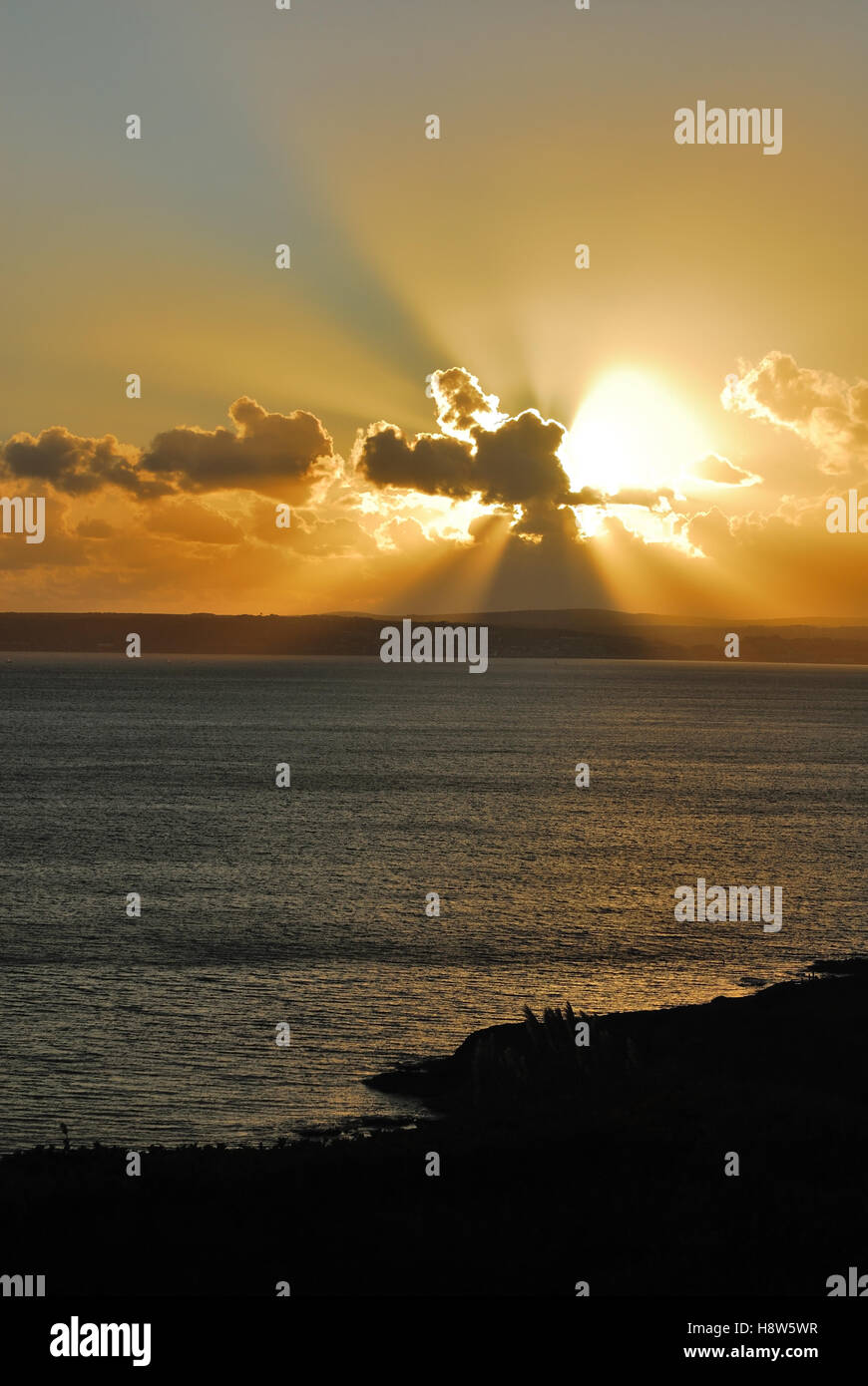 Sun-rays and clouds over the sea Stock Photo - Alamy