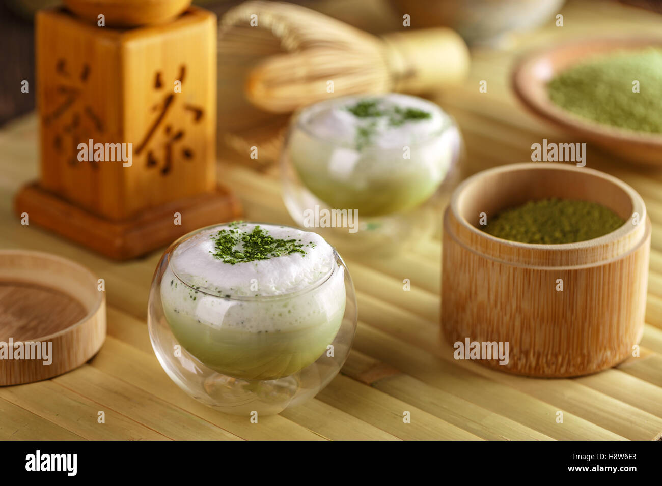Glass of matcha green tea latte on bamboo tray Stock Photo - Alamy