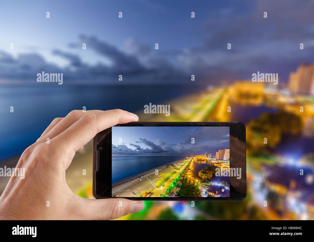 Travel concept. Hand making photo of city with smartphone camera ...