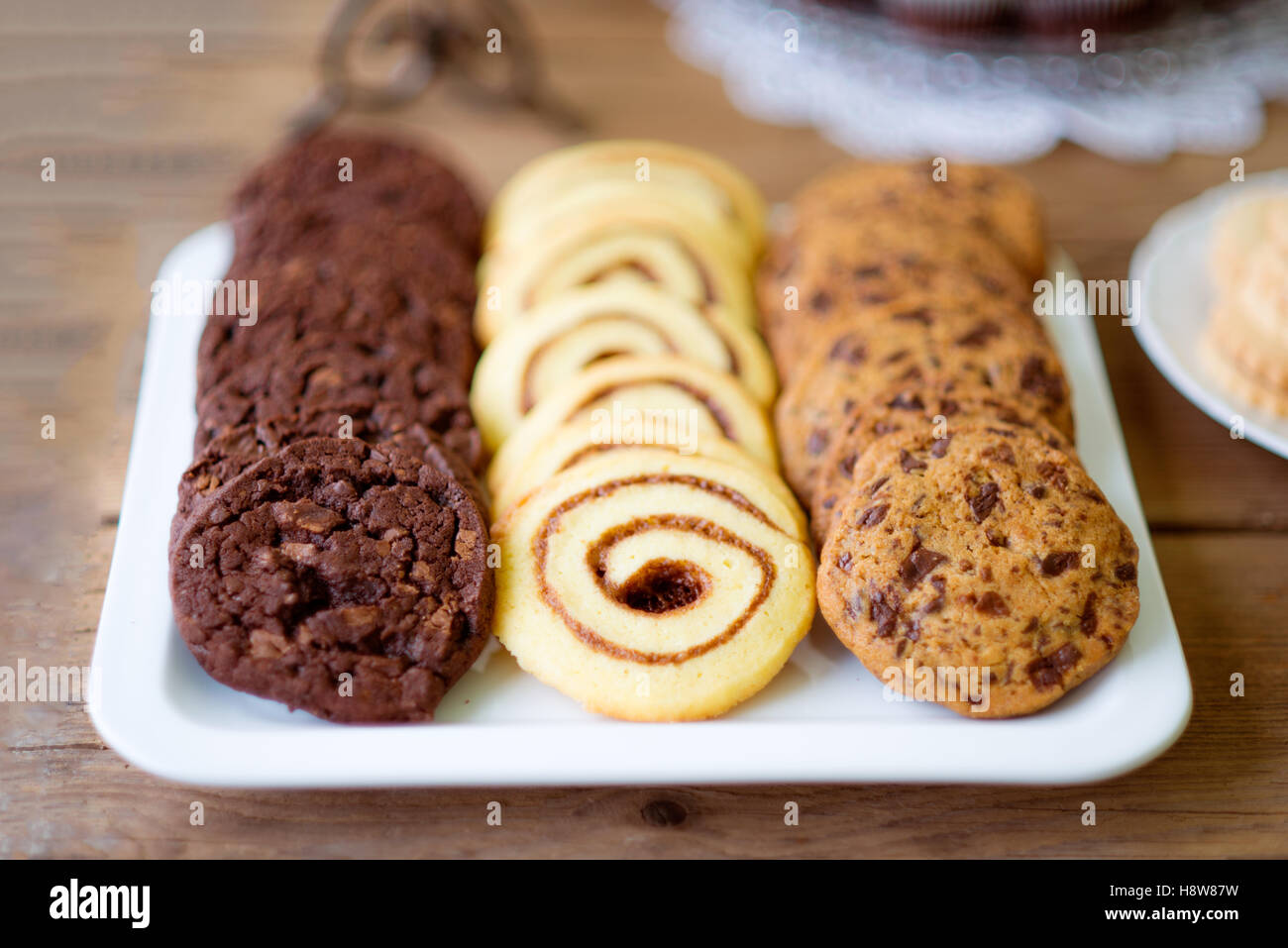 Table with various types of cookies on tray. Studio shot Stock Photo ...