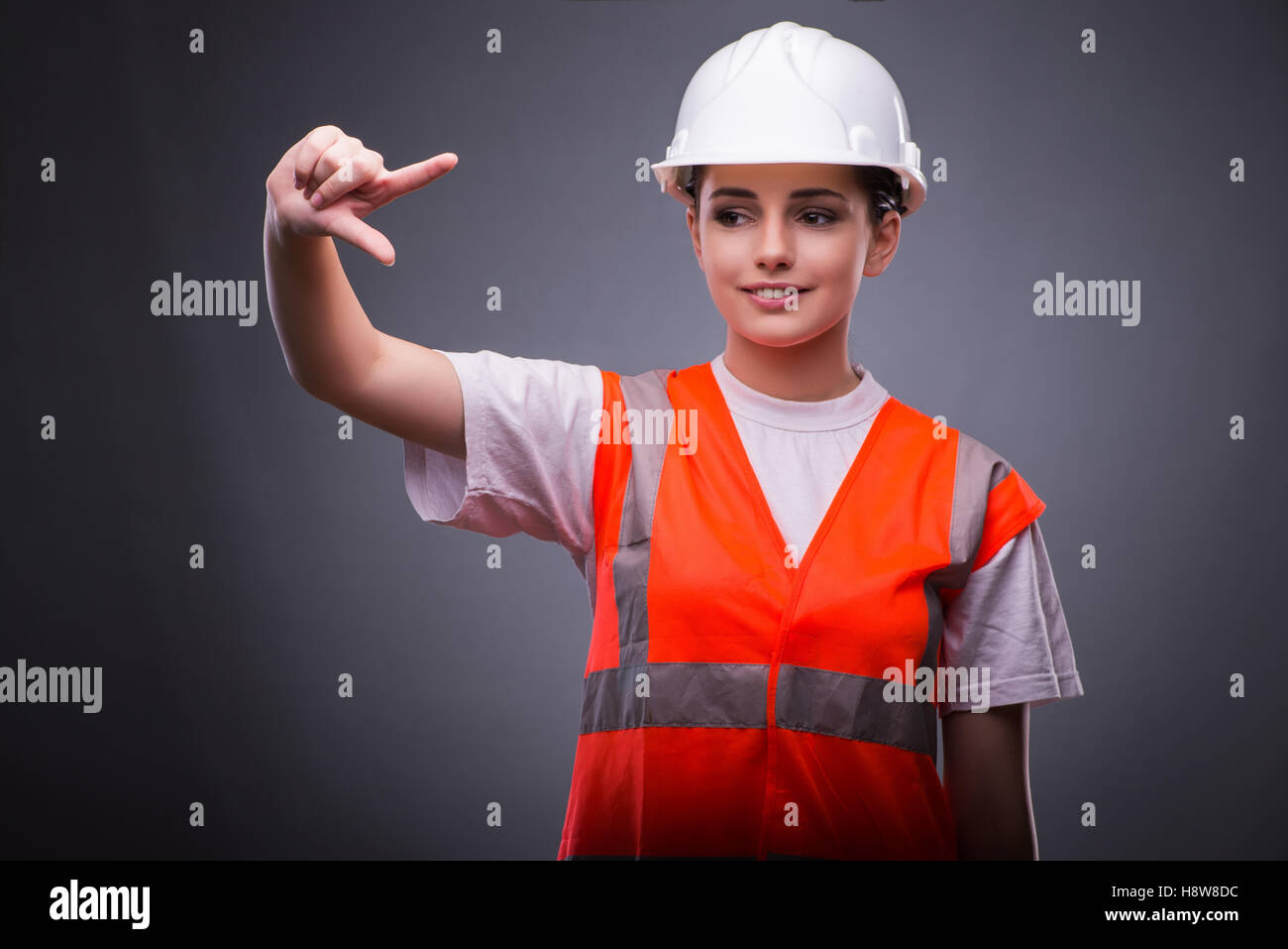 Cute construction worker pressing virtual buttons Stock Photo - Alamy