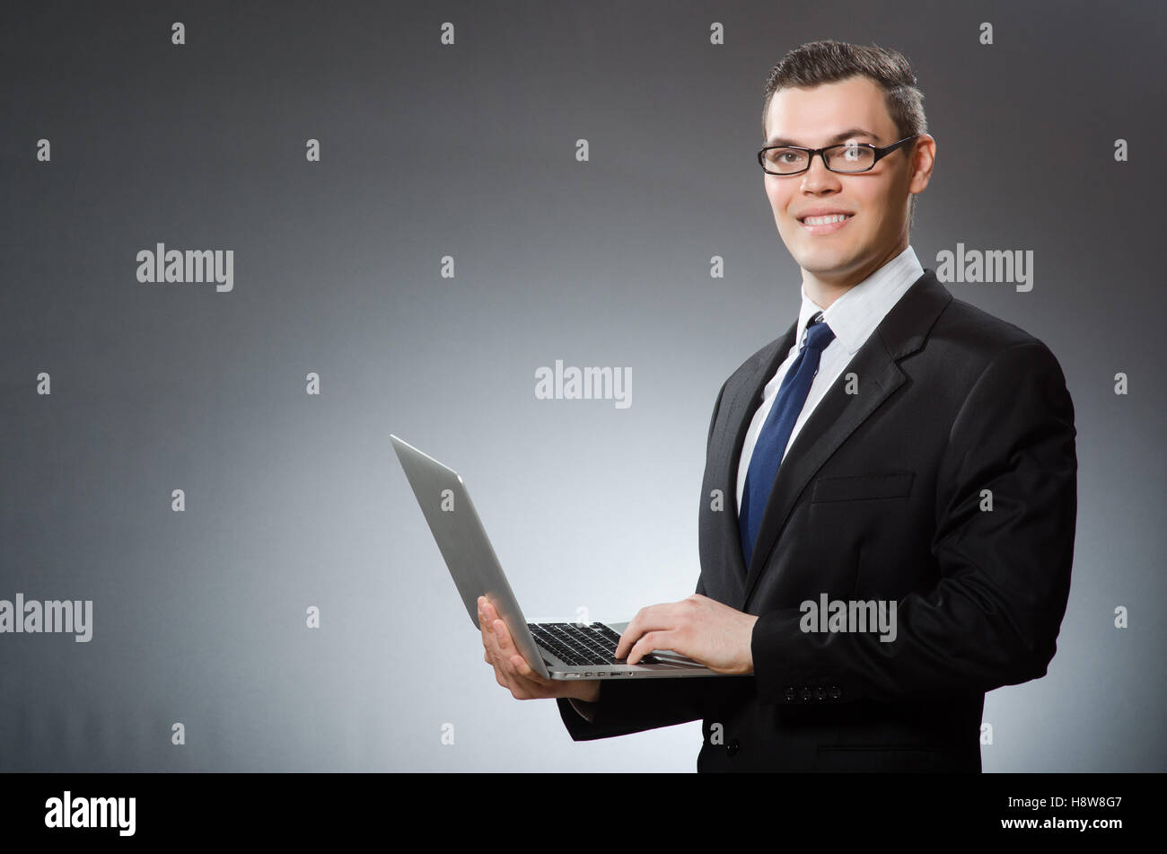 Man with laptop in business concept Stock Photo - Alamy