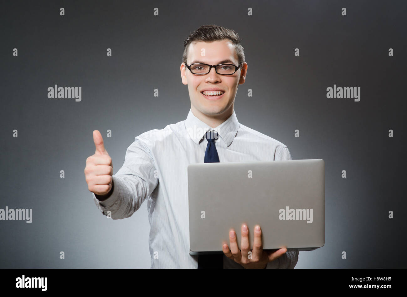 Man with laptop and thumbs up Stock Photo - Alamy