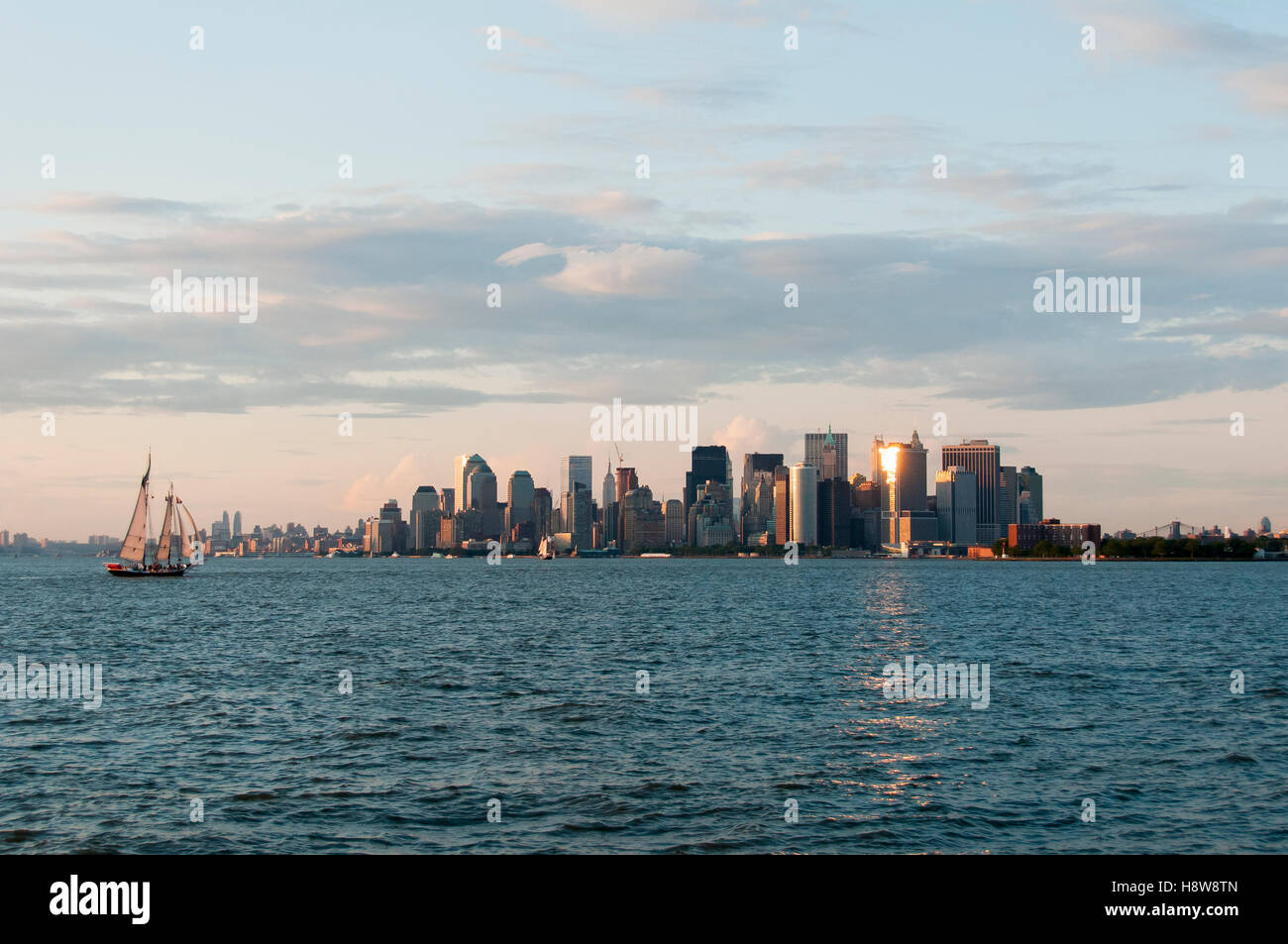 New York Manhattan skyline from bay just before sunset Stock Photo - Alamy