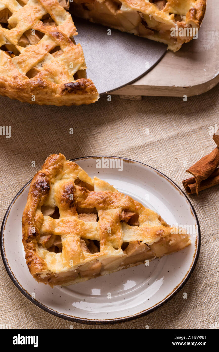 fresh baked apple pie slice on rustic table setting Stock Photo - Alamy