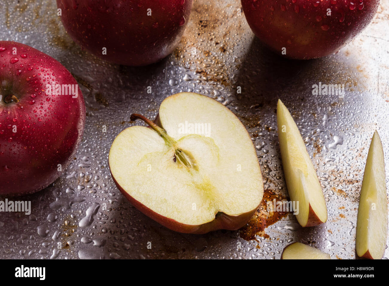 fresh shiny red sliced apple on steel plate Stock Photo - Alamy