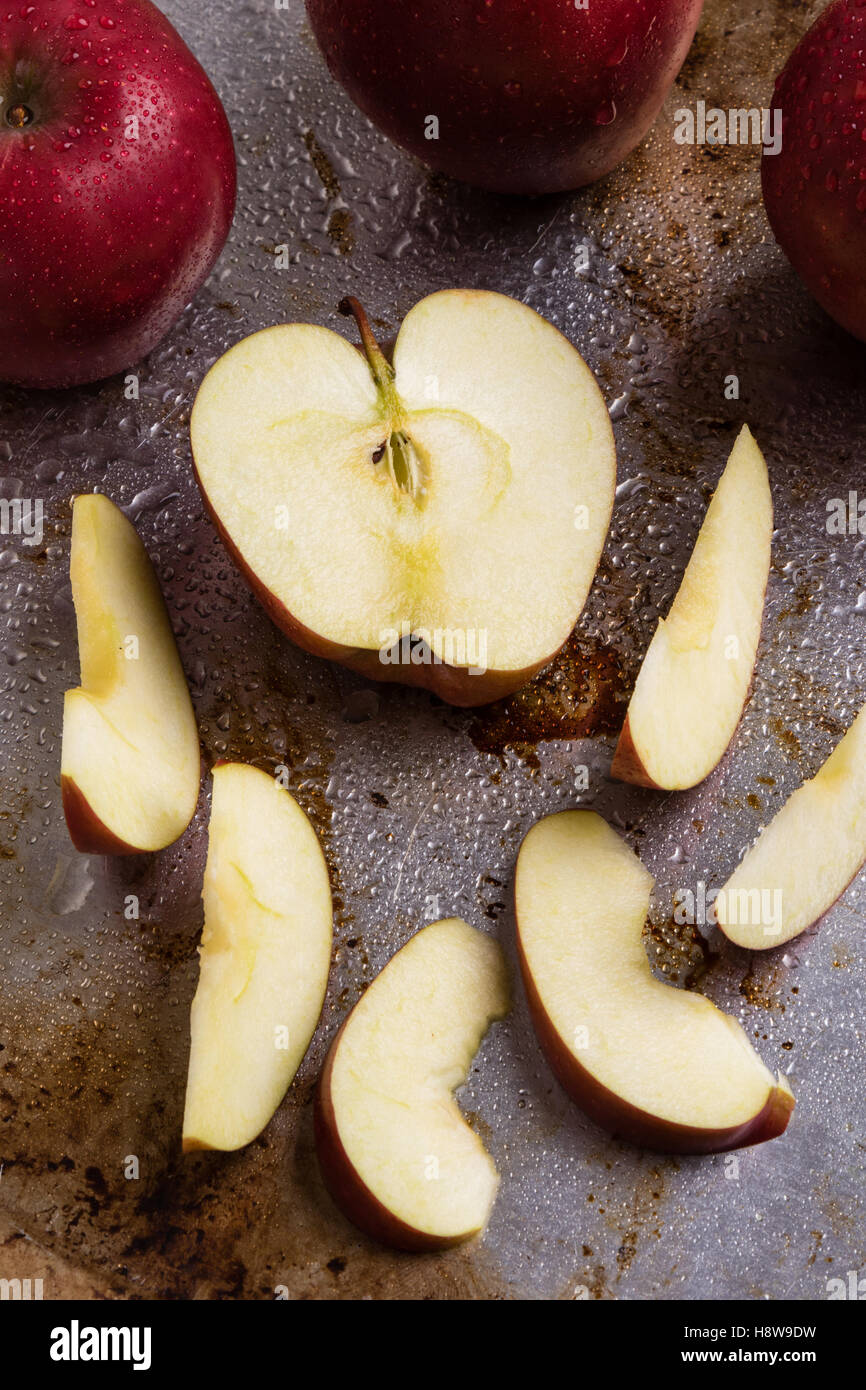 fresh shiny red sliced apple on steel plate Stock Photo - Alamy