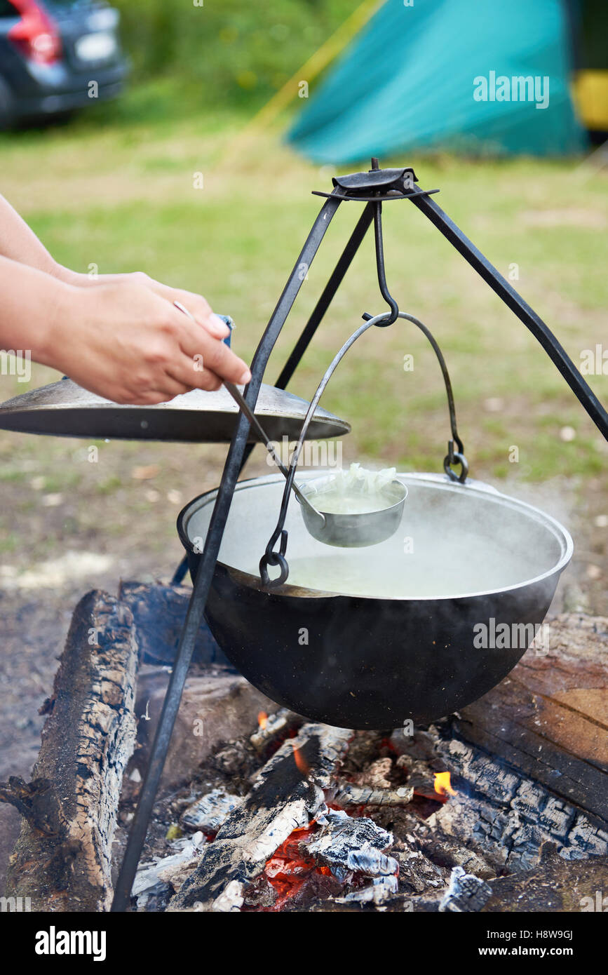 Cooking food over a campfire in a hike Stock Photo - Alamy