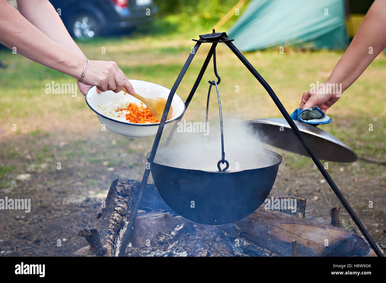 Cooking food over a campfire in a hike Stock Photo - Alamy