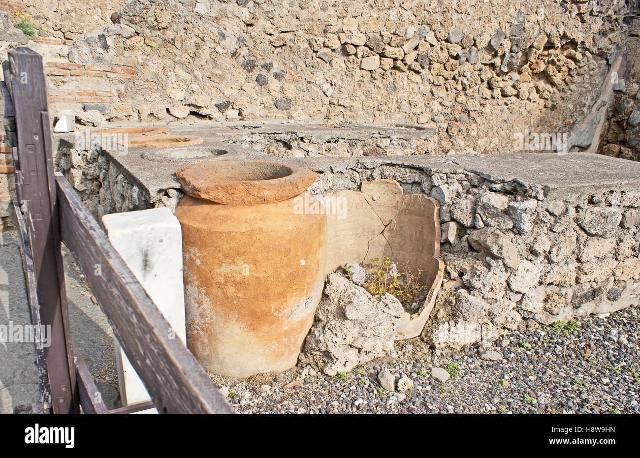 The ancient olive oil pots built in wall of the ruined building ...