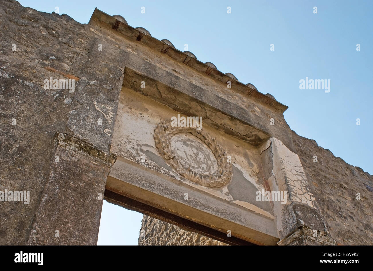 The relief of laurel wreath on the gate at the entrance to ancient ...