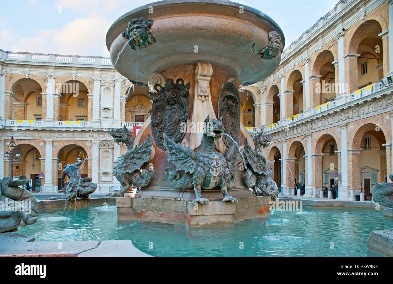The medieval stone fountain with bronze dragons, tritons and dolphins ...