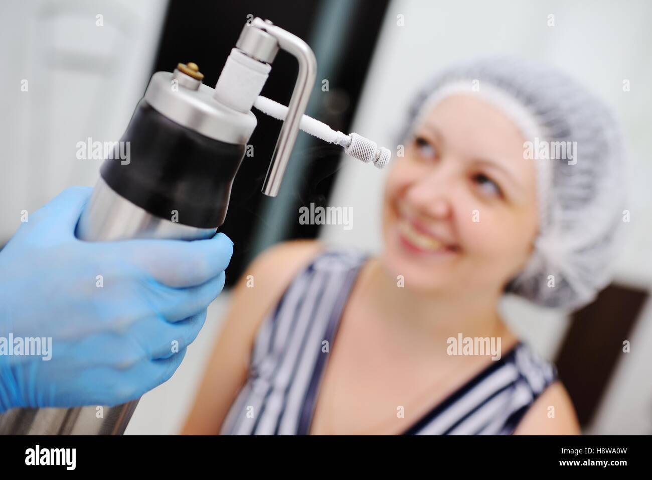 Doctor makes the patient cryotherapy procedure - Cryomassage - cold ...