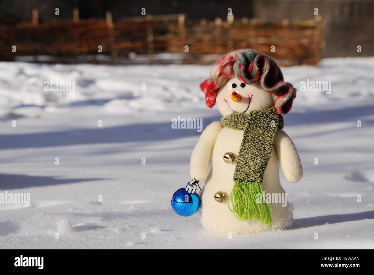 toy snowman with Christmas toys on a snow background Stock Photo - Alamy