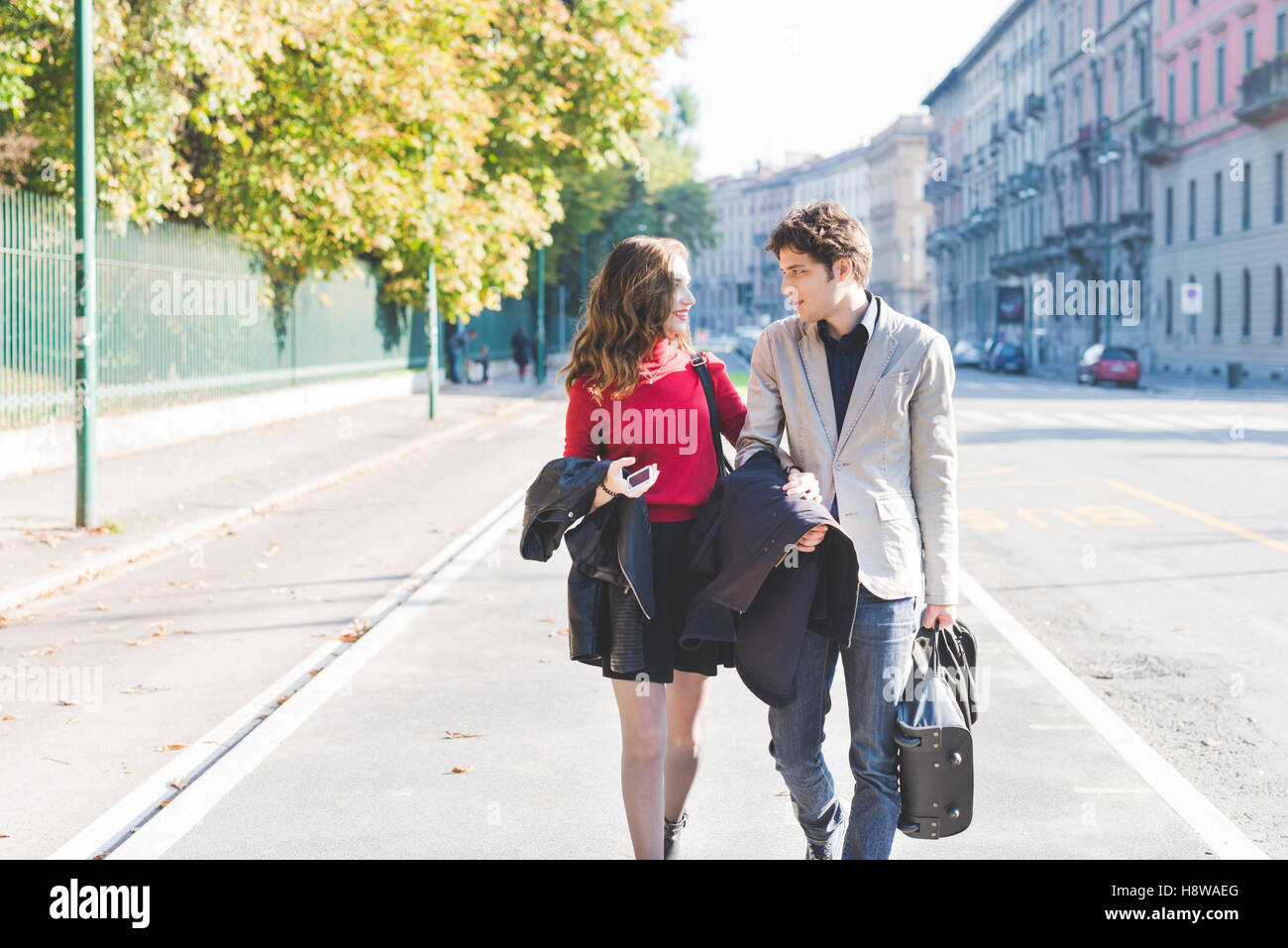 Young beautiful couple in love chatting outdoor in the city, having fun ...