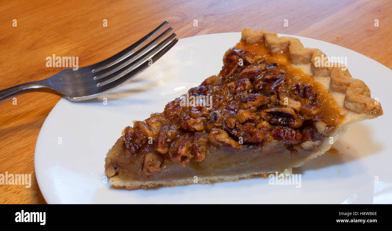 Big slice of pecan pie and a fork on a plate Stock Photo - Alamy