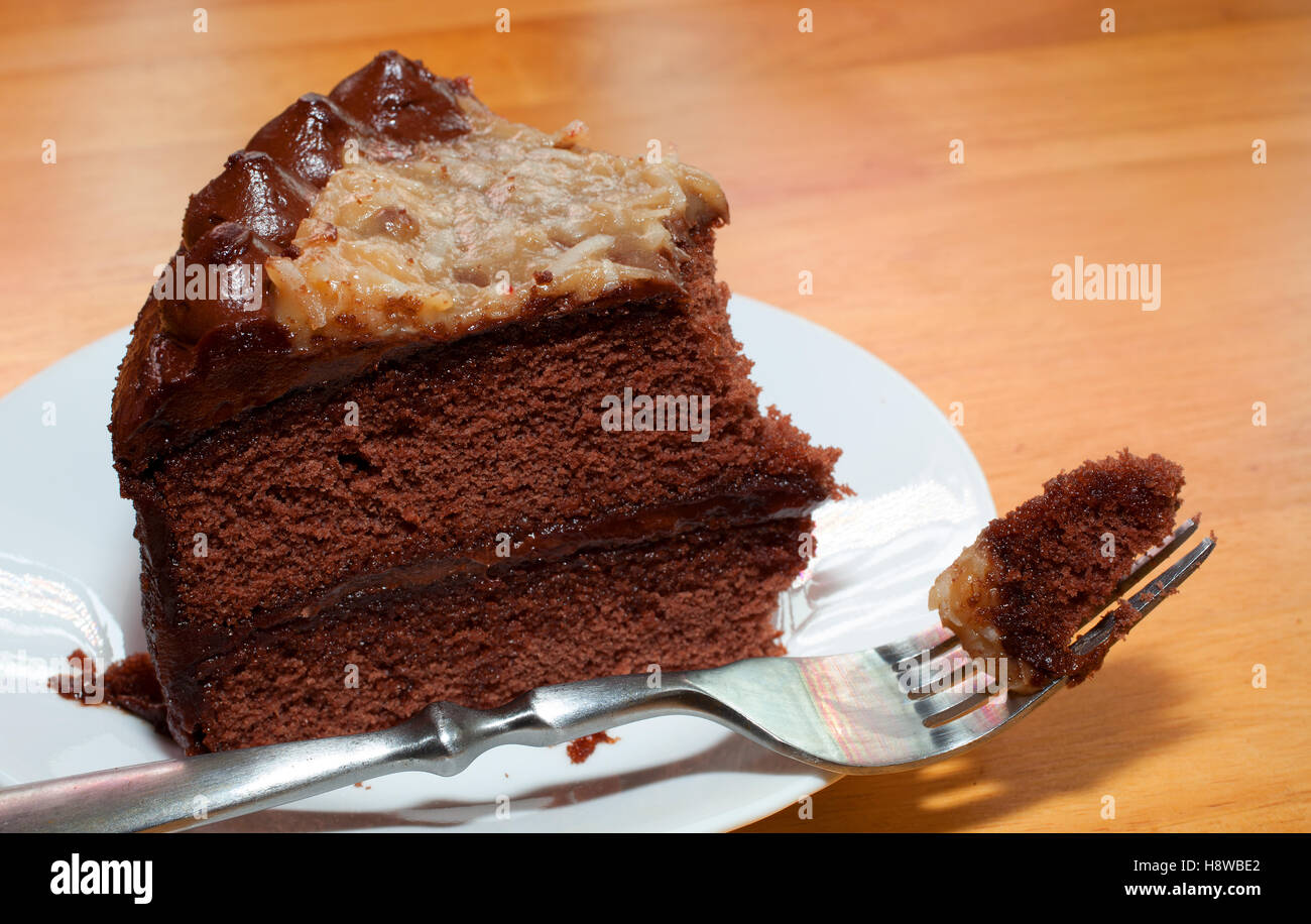 Chocolate cake on a fork and a piece that is behind Stock Photo - Alamy