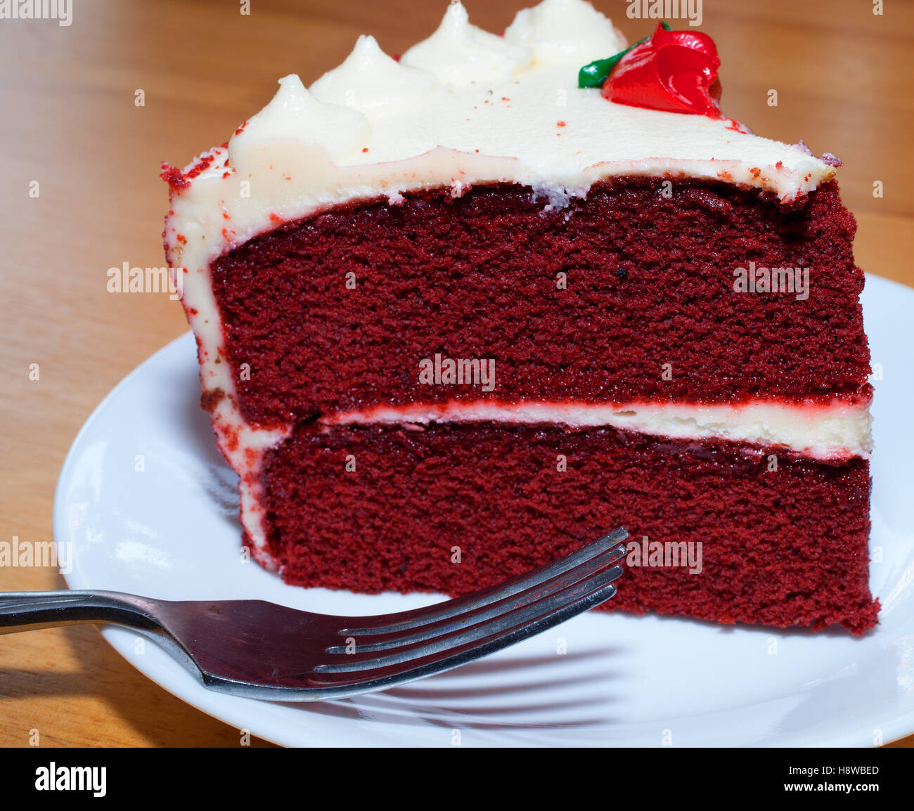 Red velvet cake on a plate with a fork Stock Photo - Alamy