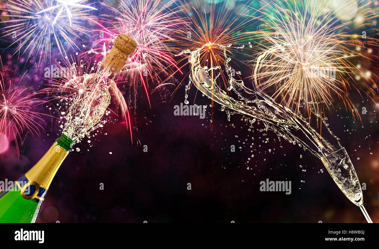 Bottle of champagne with glass over fireworks background. Celebration ...