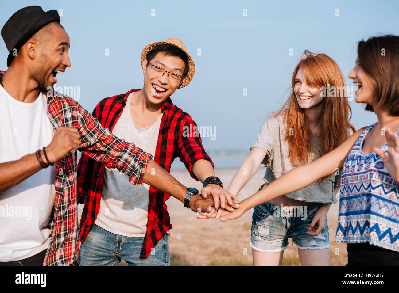 Group friends joining hands unity hi-res stock photography and images ...