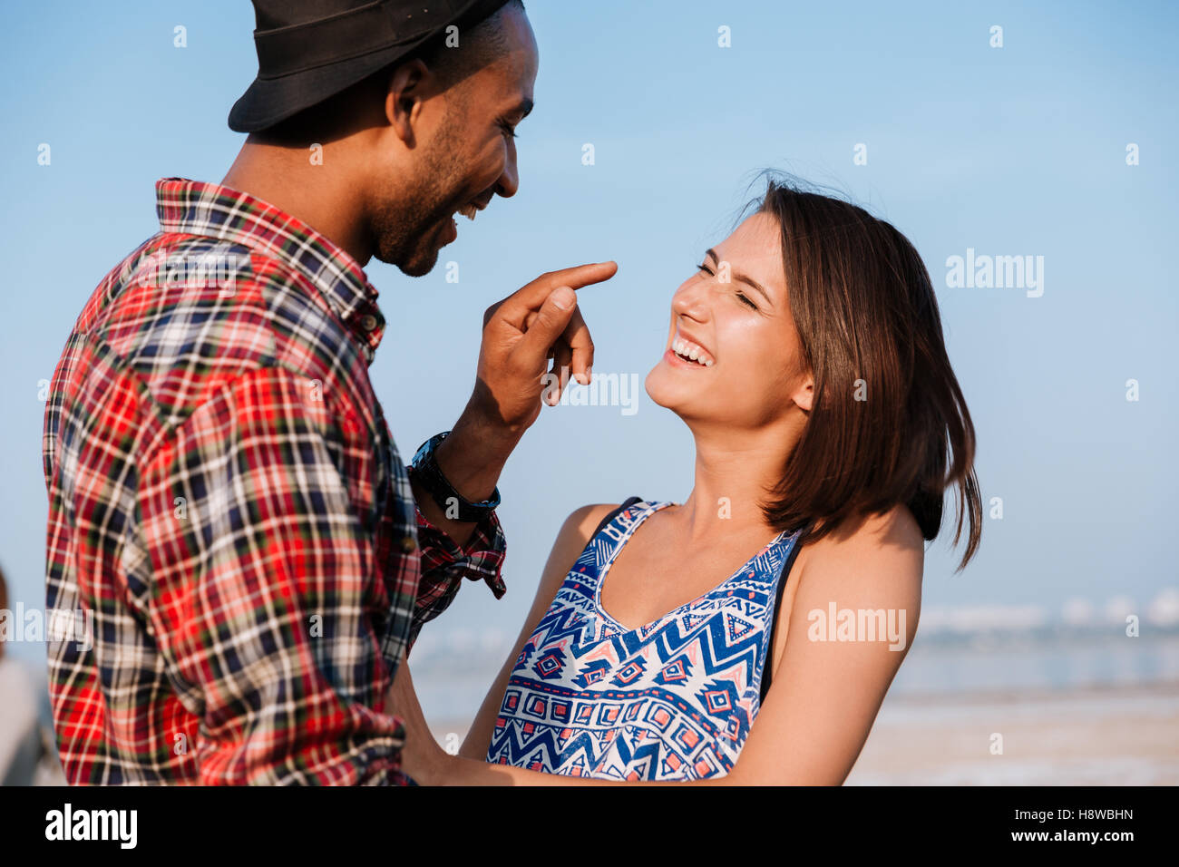 Happy young couple laughing and having fun outdoors Stock Photo - Alamy