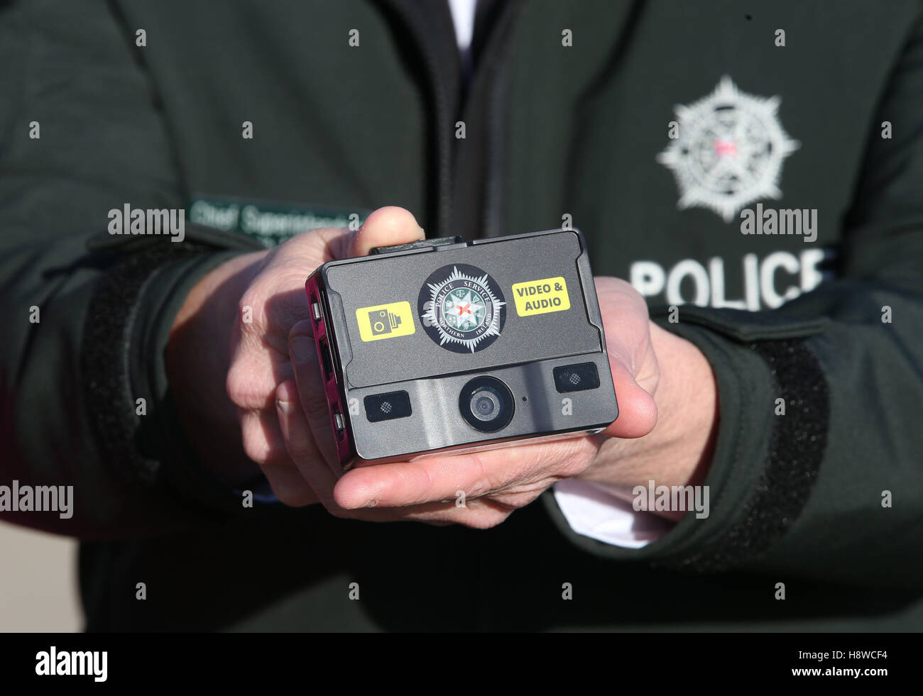 A police officer holds a body worn camera at a Police Service of ...
