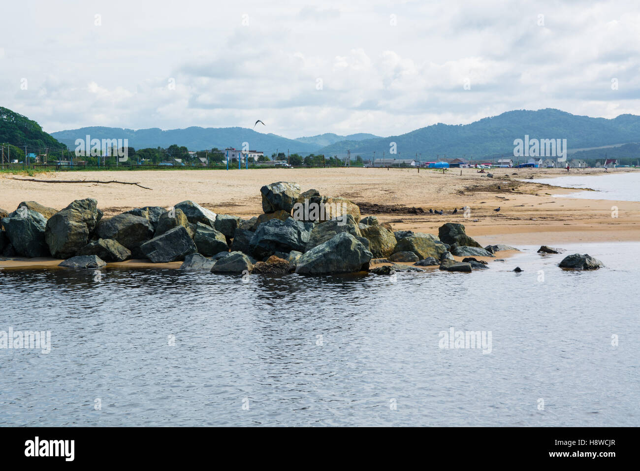 Sandy beach and big boulders on the shore. Sea landscape Stock Photo ...
