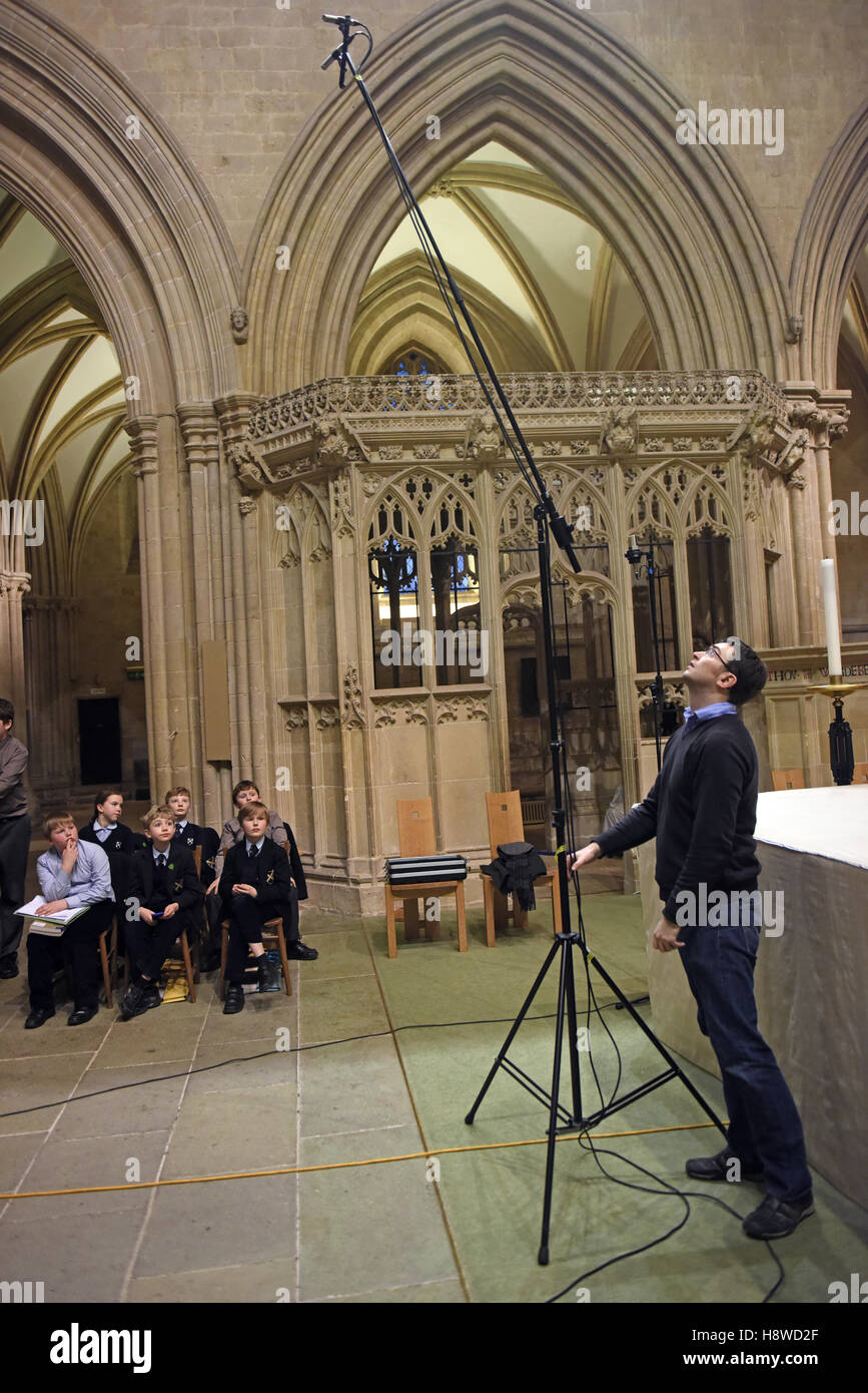 Choristers being conducted by choir master at a recording session for a ...