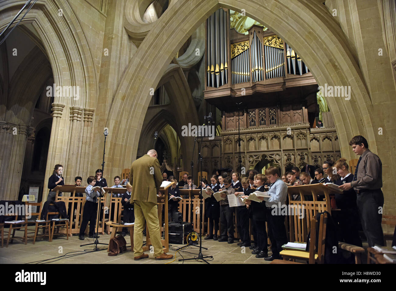 Choristers being conducted by choir master at a recording session for a ...