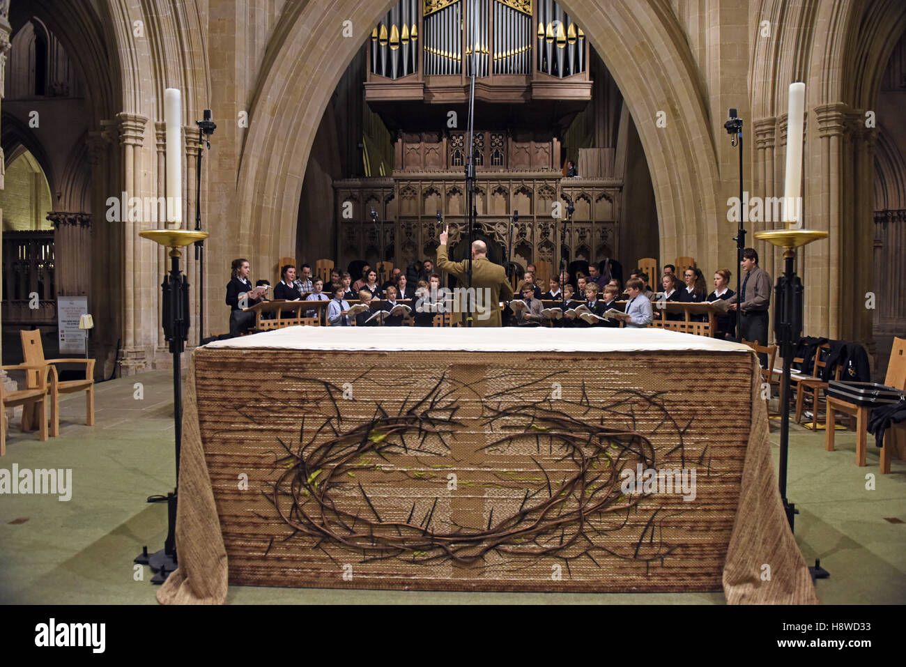 Choristers being conducted by choir master at a recording session for a ...