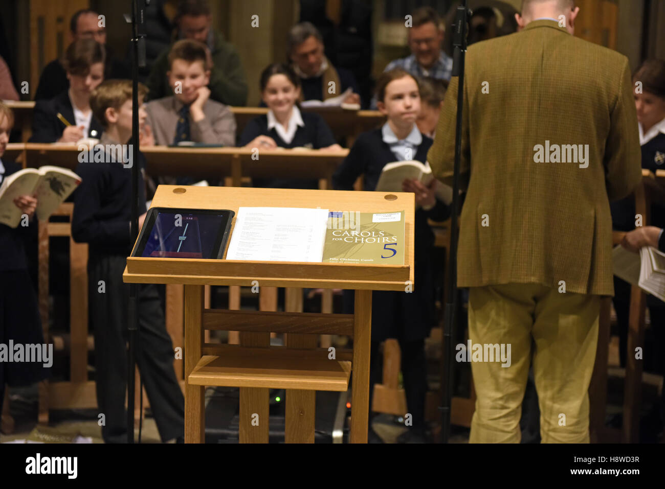 Choristers being conducted by choir master at a recording session for a ...