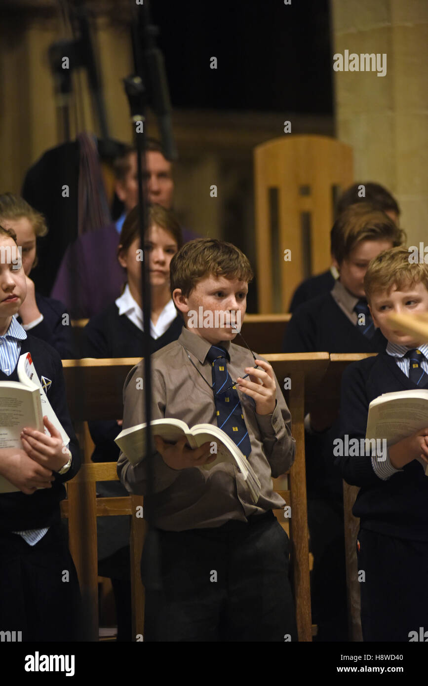 Choristers being conducted by choir master at a recording session for a ...