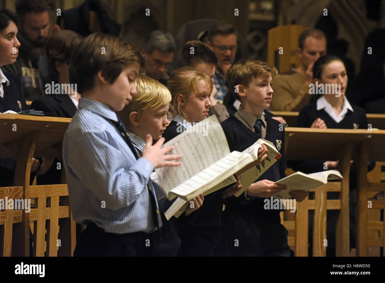Choristers being conducted by choir master at a recording session for a ...