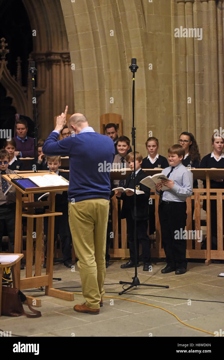 Choristers being conducted by choir master at a recording session for a ...