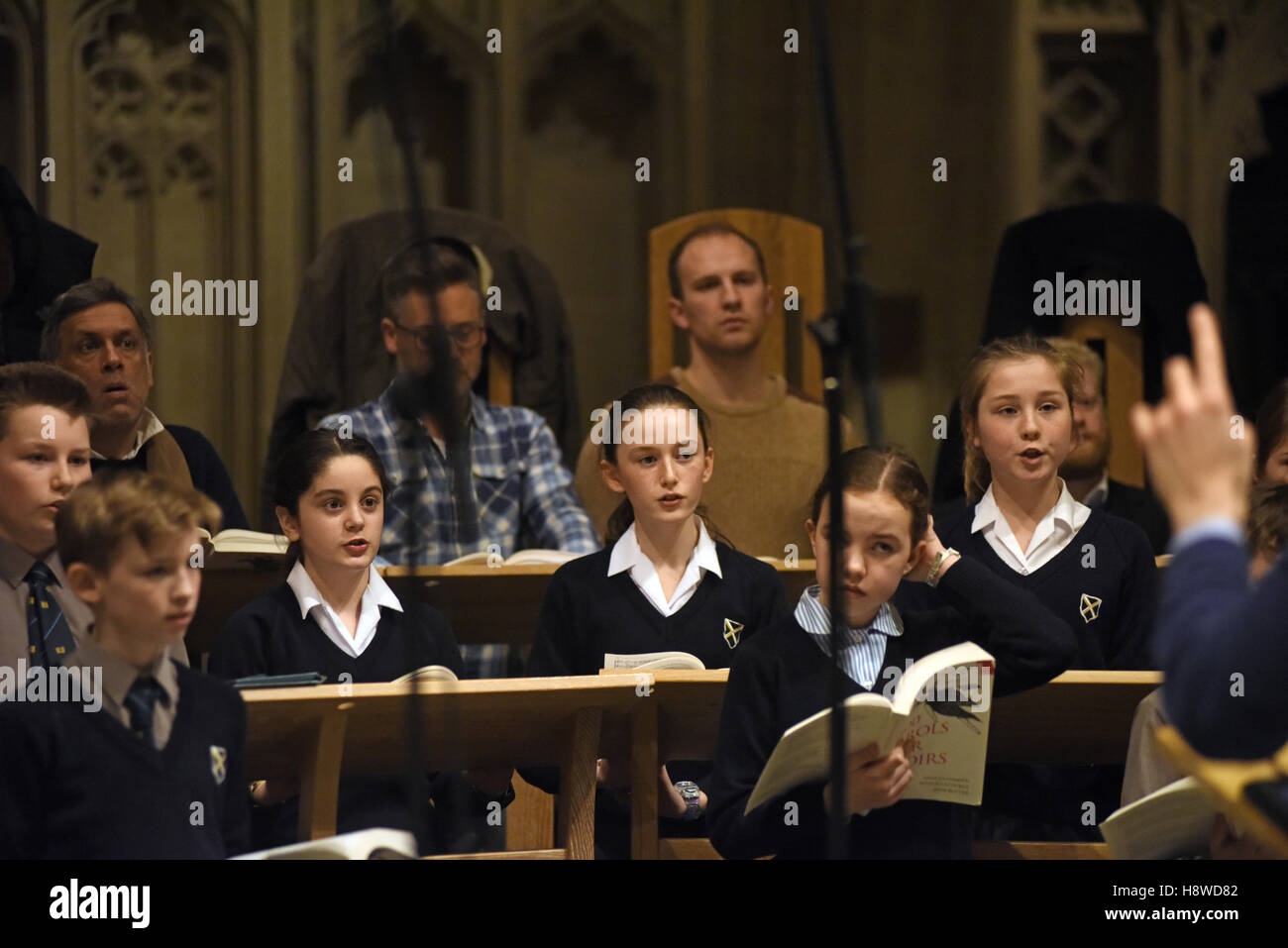 Choristers being conducted by choir master at a recording session for a ...