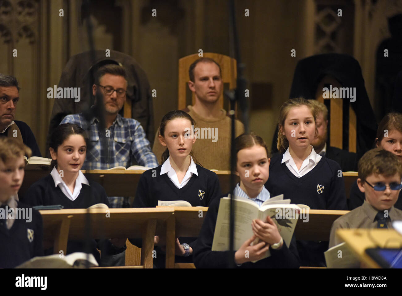 Choristers being conducted by choir master at a recording session for a ...