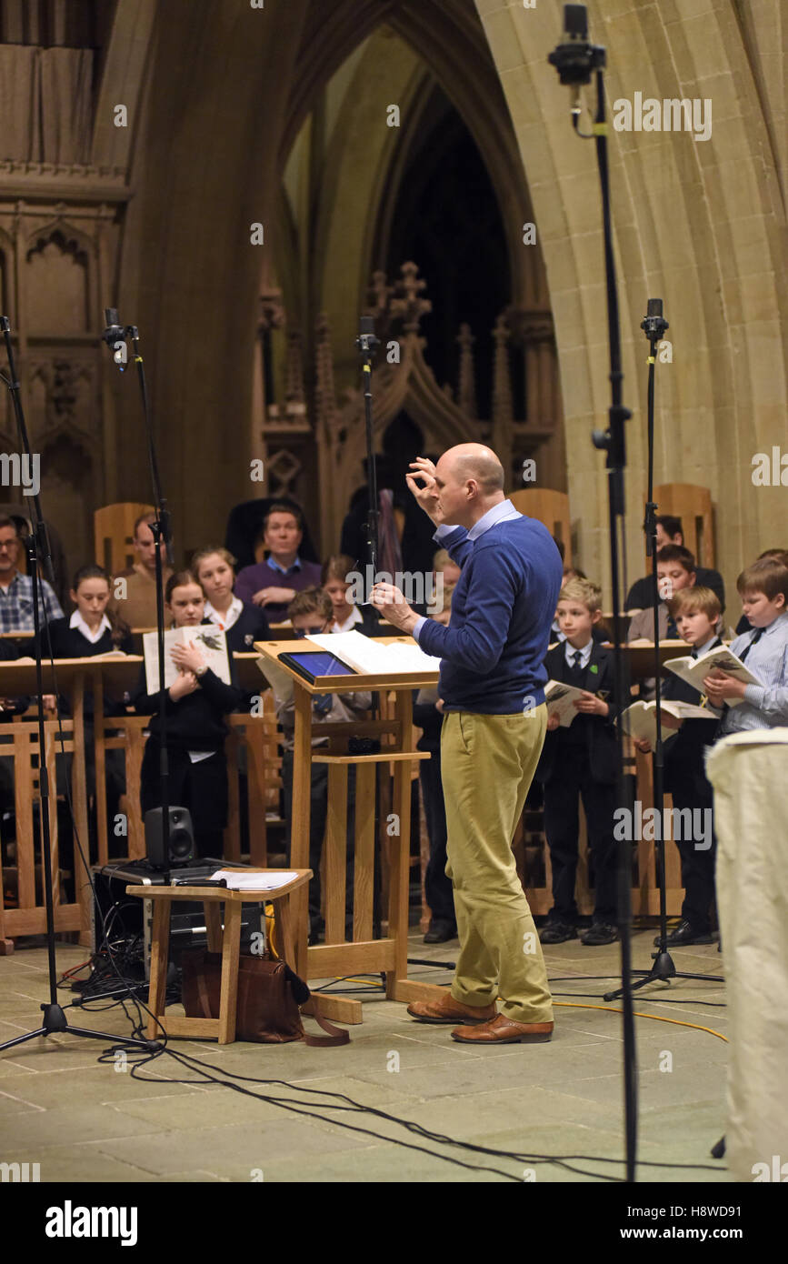 Choristers being conducted by choir master at a recording session for a ...